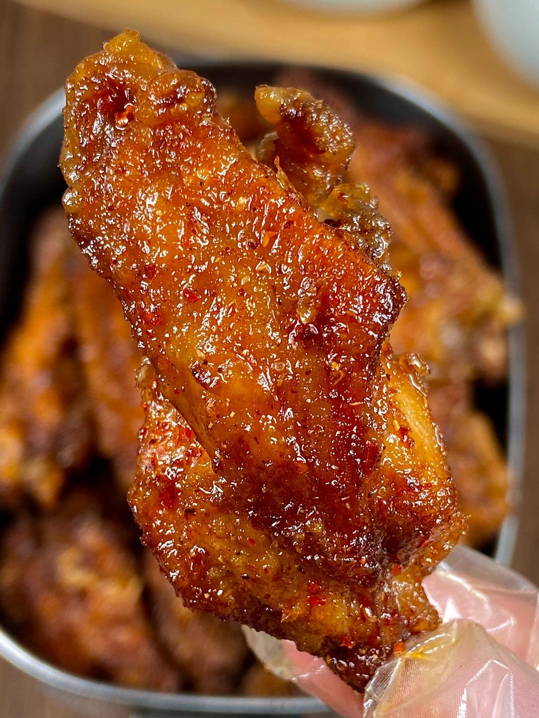 The crispy chicken wings are charred and fragrant, and coated with a ...